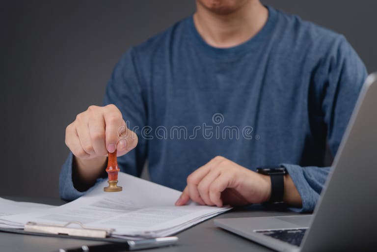 Professional Office Worker Using a Stamp on Paperwork, Demonstrating ...