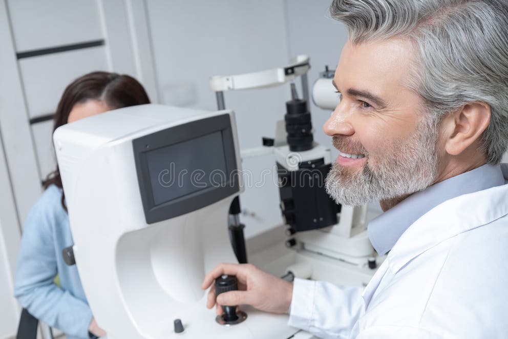 Professional Optometrist in Clinic Sitting at Workplace with Advanced ...