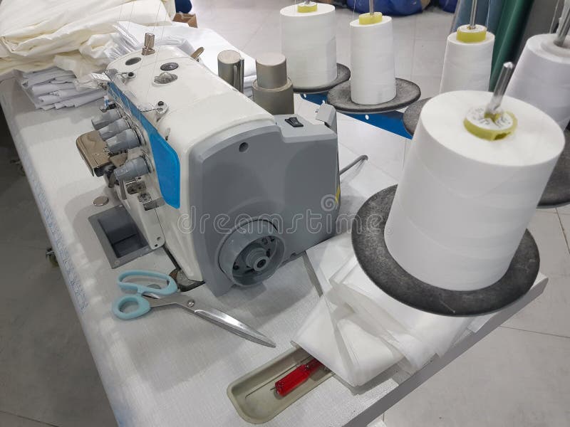 Professional Overlock Sewing Machine with White Thread in Workshop ...
