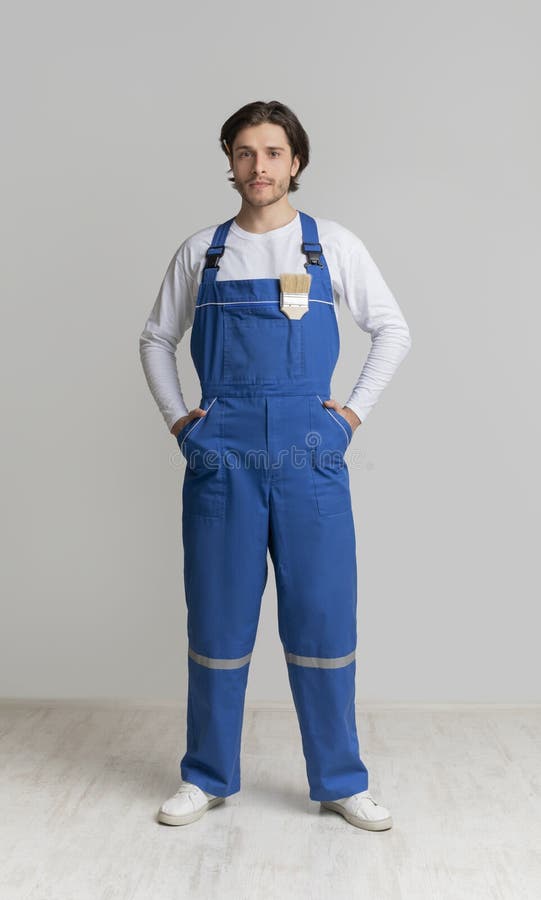 Renovation Services. Smiling Painter in Uniform with Painting Tools in ...