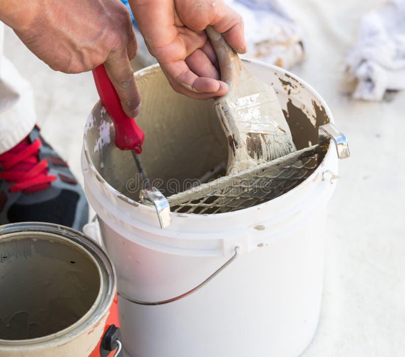 Professional Painter Loading Paint Onto Brush from Bucket Stock Photo ...
