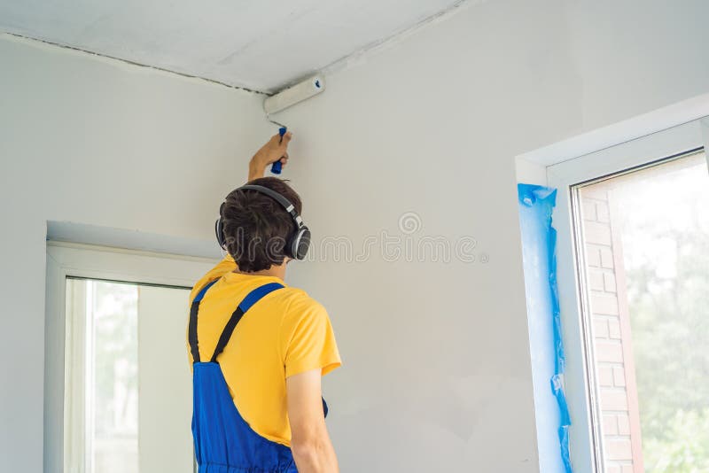Professional Painter Worker Painting and Priming Wall with Painting ...