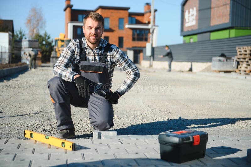Professional Paver Worker Lays Paving Stones in Layers for Pathway ...