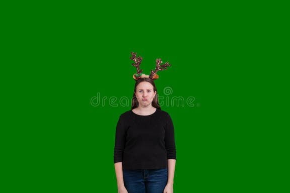 Women Wearing Christmas Reindeer Antlers Puckered Lips Frowning Stock ...