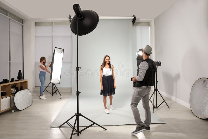 Professional Photographer and Assistant Working with Model Stock Photo ...
