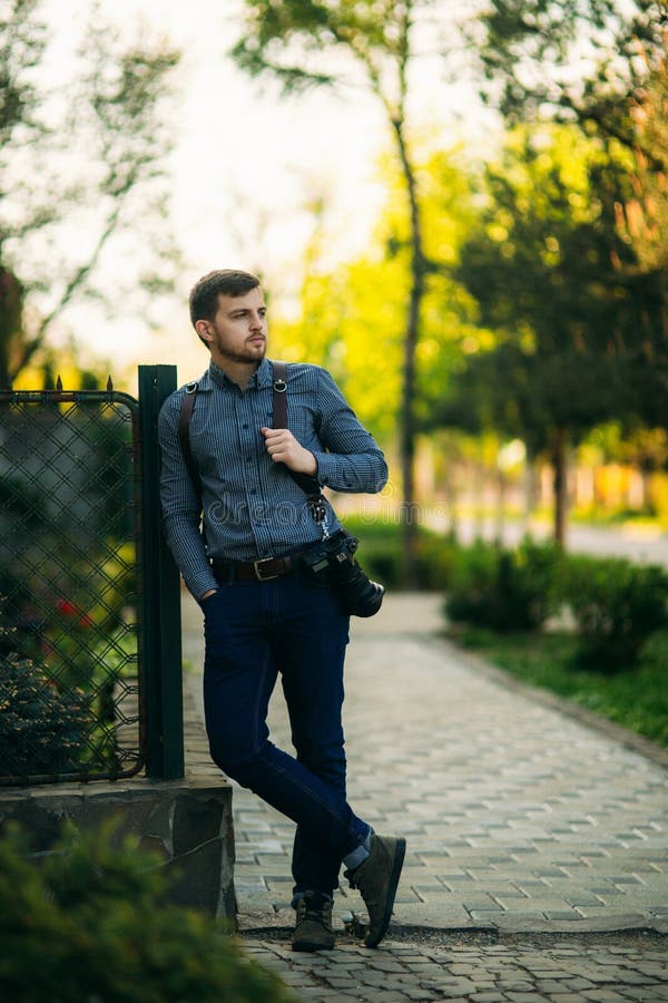 Professional Photographer with Camera Stand Outside and Wait for the ...
