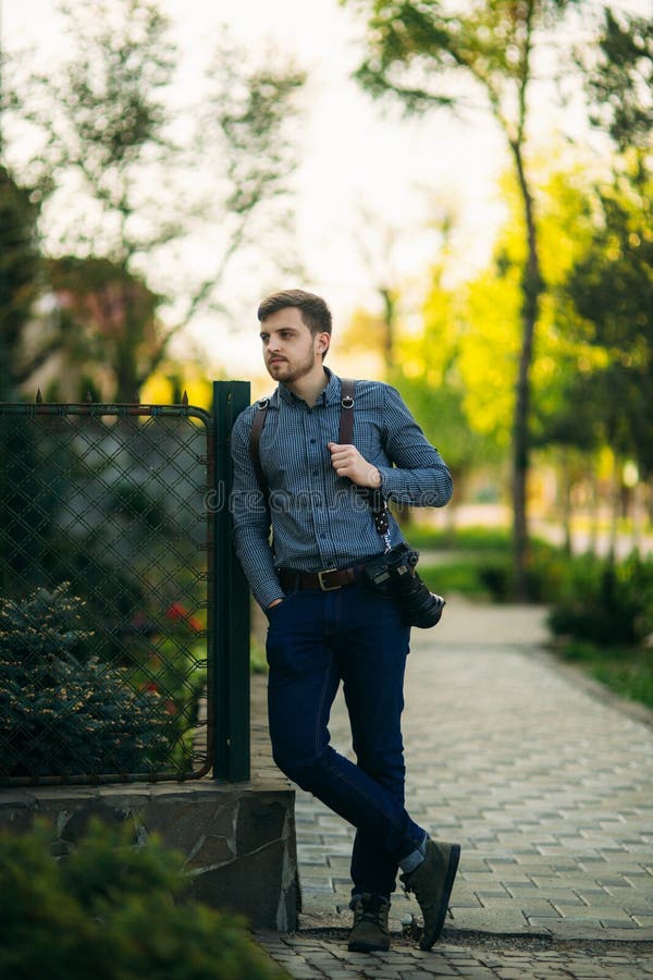 Professional Photographer with Camera Stand Outside and Wait for the ...