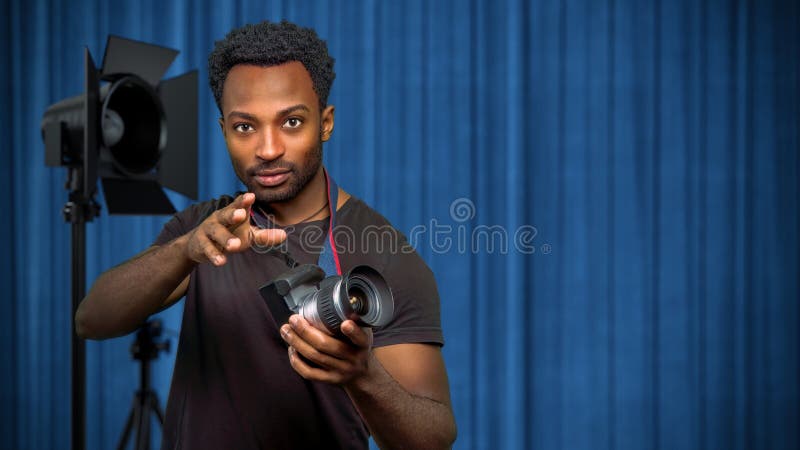 Professional Photographer Working in His Studio Holding Camera and ...