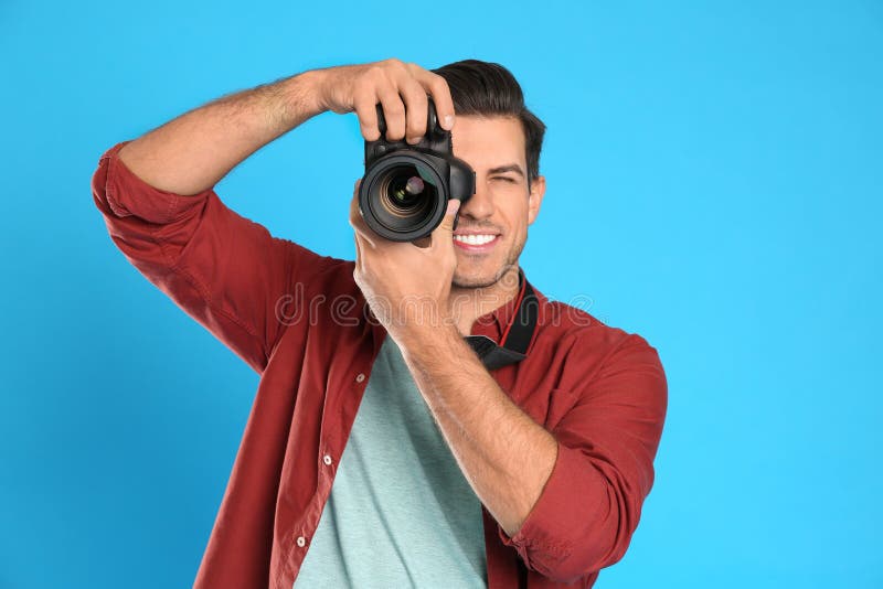 Professional Photographer Working on Blue Background in Studio Stock ...