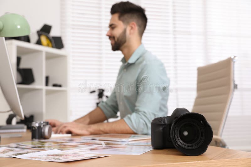 Professional Photographer Working at Table in Office Stock Photo ...