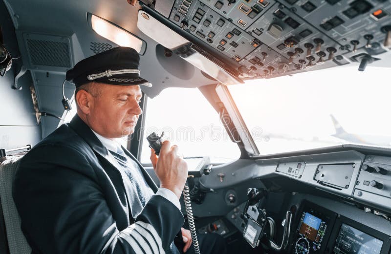 A Professional Pilot is in the Cockpit Stock Image - Image of interior ...