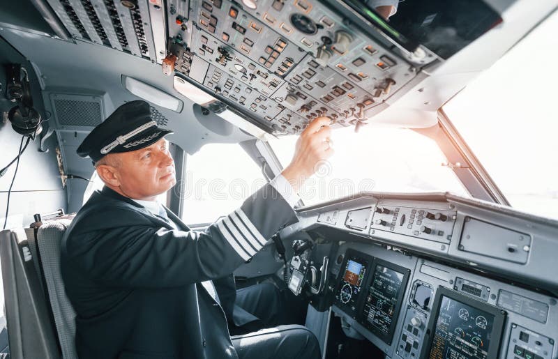A Professional Pilot is in the Cockpit. Conception of Work Stock Image ...