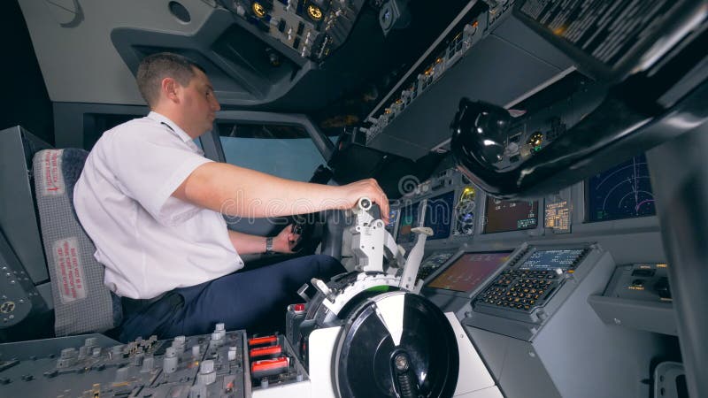 Professional Pilot is Moving a Control Wheel and a Lever during the ...