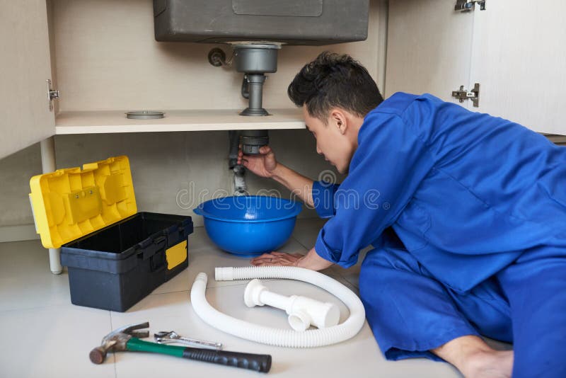 Plumber fixing pipe stock photo. Image of male, young - 120275476