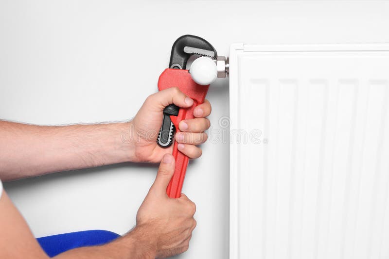 Professional Plumber Using Adjustable Wrench for Installing New Heating ...
