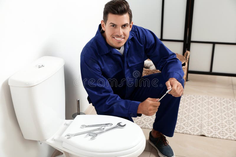 Professional Plumber Working with Toilet Bowl Stock Photo - Image of ...