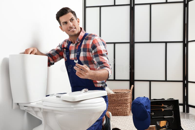 Professional Plumber Working with Toilet Bowl Stock Photo - Image of ...