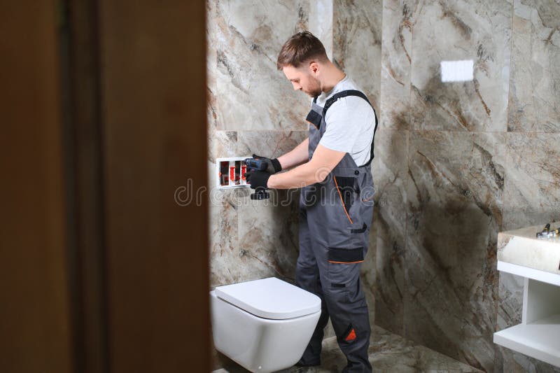 Professional Plumber Working with Toilet Bowl in Bathroom Stock Image ...
