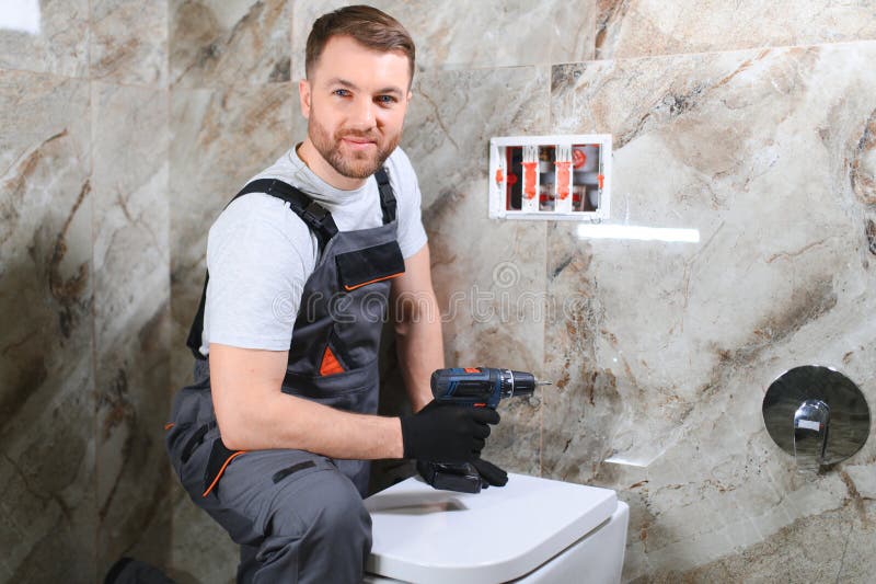 Professional Plumber Working with Toilet Bowl in Bathroom Stock Image ...