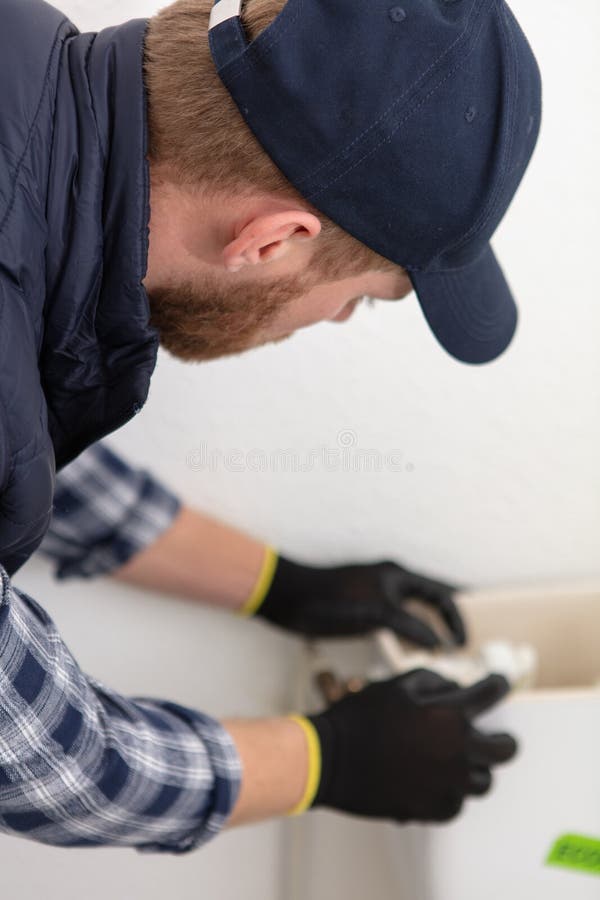 Professional Plumber Working with Toilet Cistern in Bathroom Stock ...