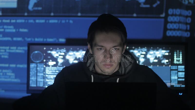 Geek Hacker Programmer is Working on Computer in Cyber Security Center Filled with Display ...