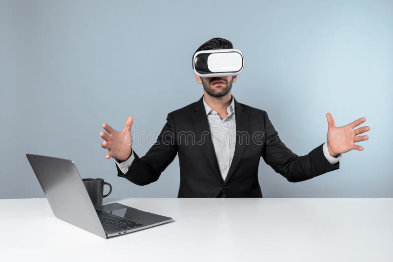 Project Manager Looking by Using VR Goggle while Sitting at Laptop ...