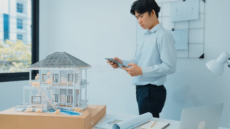 Professional Project Manager Using Tablet To Check House Model ...