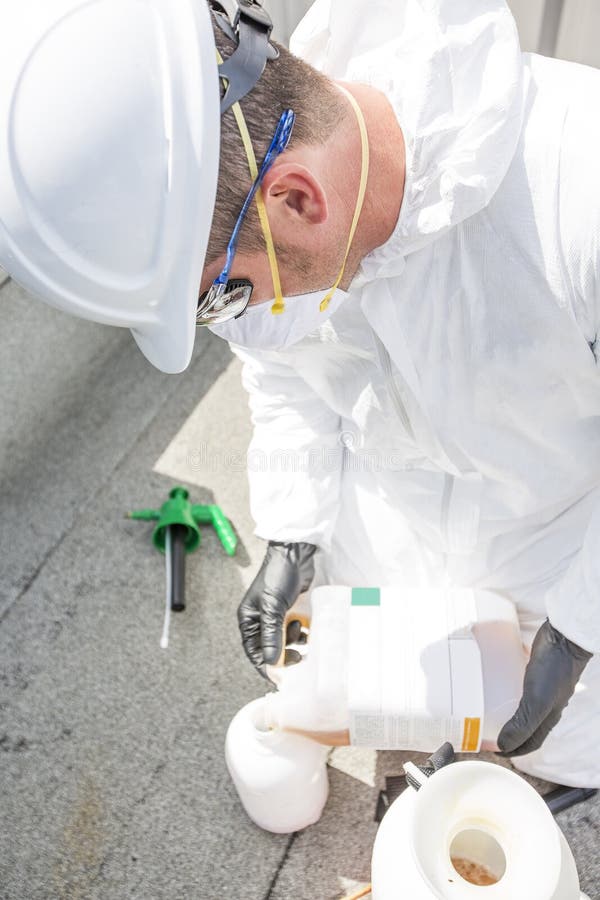 Professional in Protective Uniform, Mask, Gloves in the Roof for ...