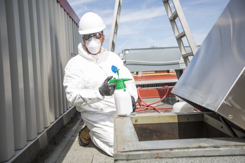 Professional in Protective Uniform, Mask, Gloves in the Roof for ...