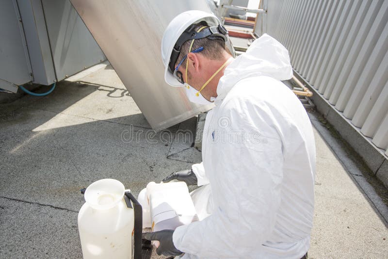Professional in Protective Uniform, Mask, Gloves in the Roof for ...