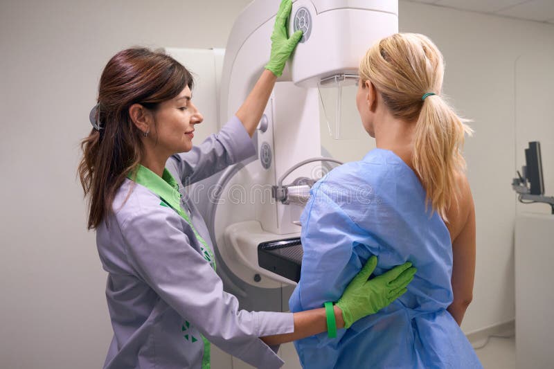Professional Radiographer Preparing Client for Diagnostic Mammogram ...