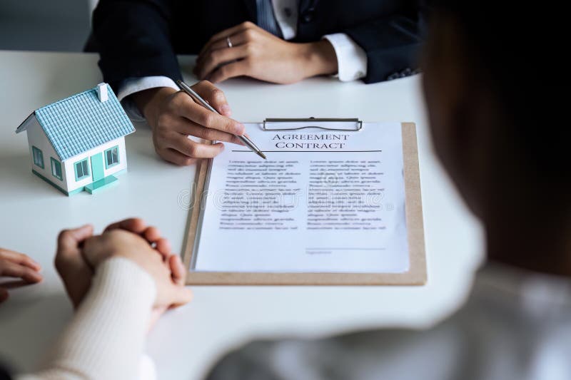 Professional Real Estate Agent Explaining the Document Process To the ...