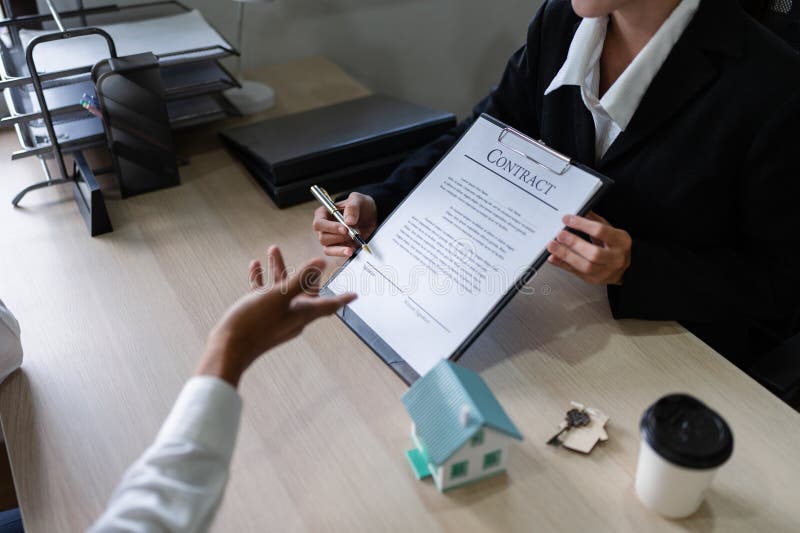 Professional Real Estate Agent Guiding and Explaining the Document Process To the Customer Stock ...