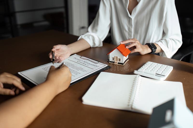 Professional Real Estate Agent Guiding and Explaining the Document ...