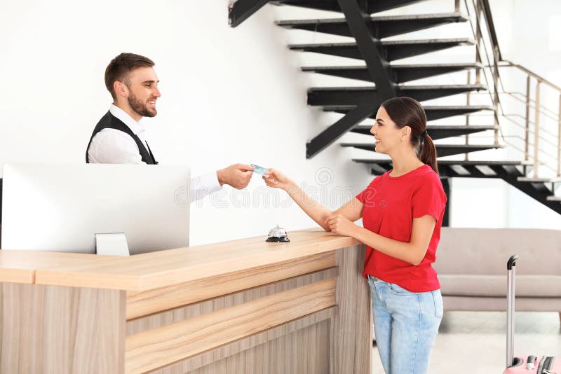 Professional Receptionist Working with Client at Desk Stock Image ...