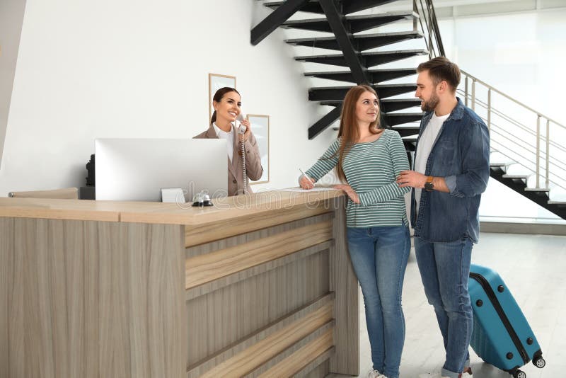 Professional Receptionist Working with Client at Desk in Hotel Stock ...