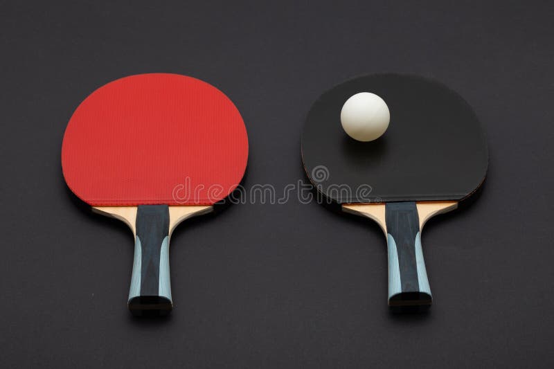 Professional Red and Black Table Tennis Paddles with Ball on Dark ...