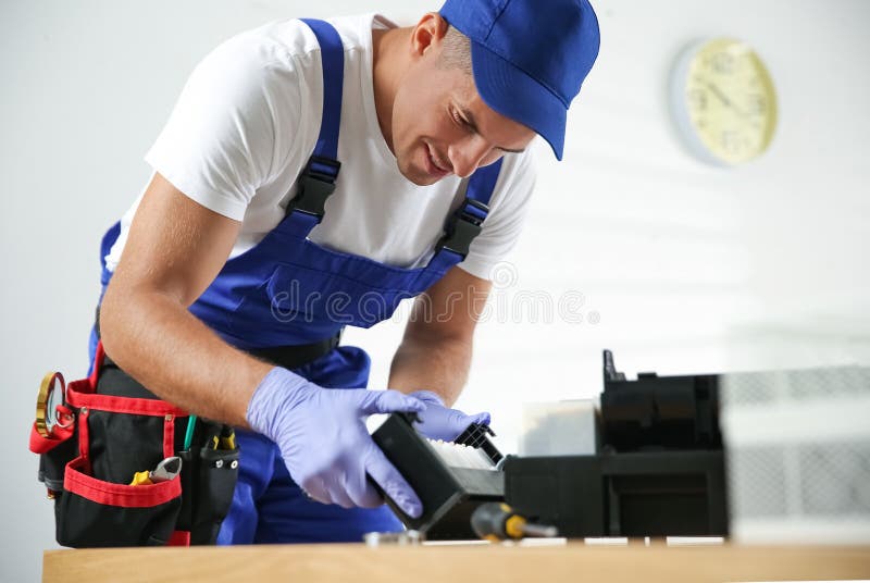 Professional Repairman in Uniform with Phone on Light Blue Background ...
