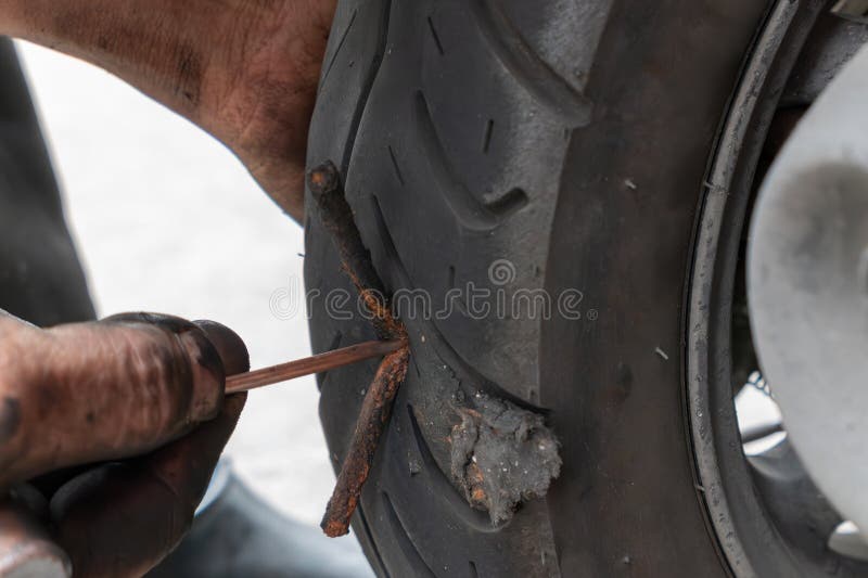 Professional Repairman Installing a Patch and Fixing a Tire Stock Photo ...