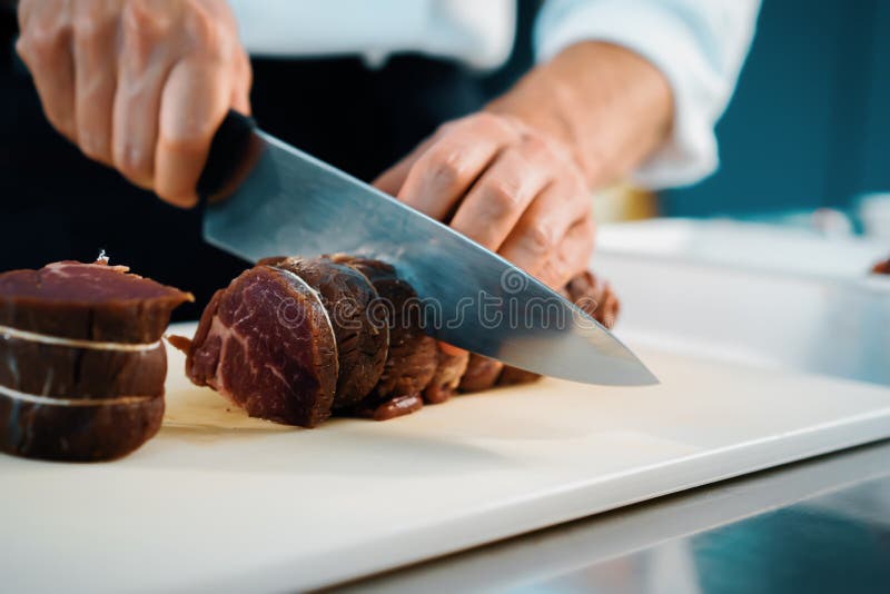 Professional Restaurant Kitchen, Close-up: Chef Cut Meat for Filet ...
