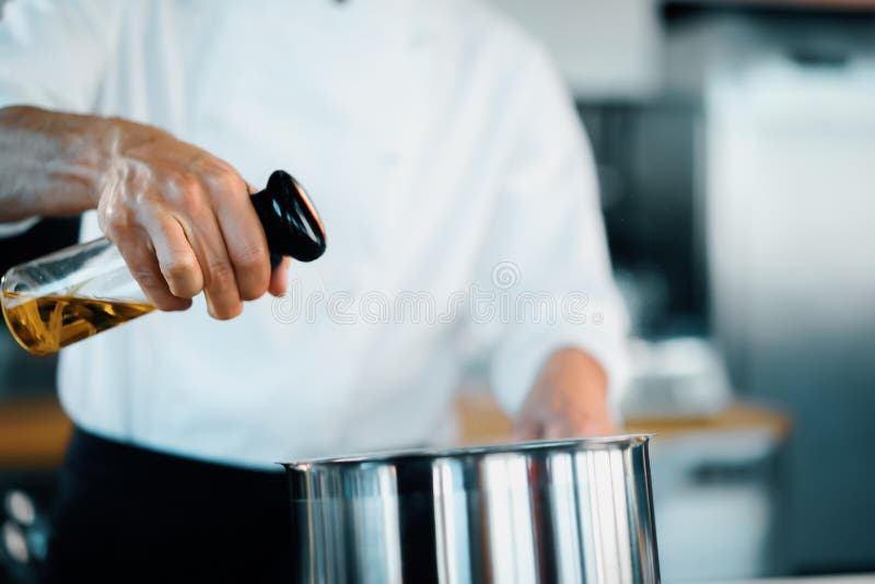 Professional Restaurant Kitchen, Close-up: the Chef Splashes Oil on the ...