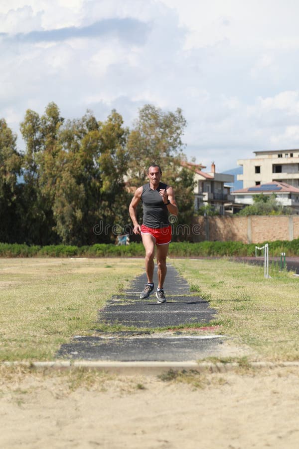 Athlete Jumping in the Sand To Prepare for Competition Stock Image ...