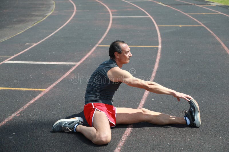 Athlete on a Racing Track Stretching after the Run Stock Photo - Image ...
