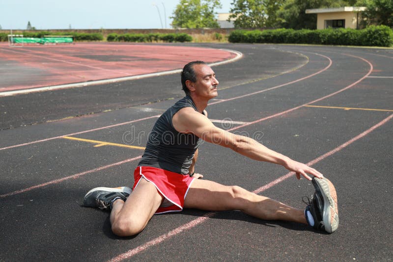 Athlete on a Racing Track Stretching after the Run Stock Image - Image ...