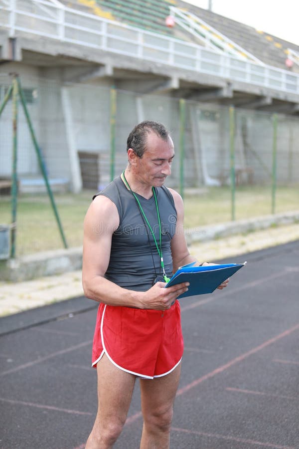 Coach Following the Paper Workout Plans Stock Photo - Image of coach ...