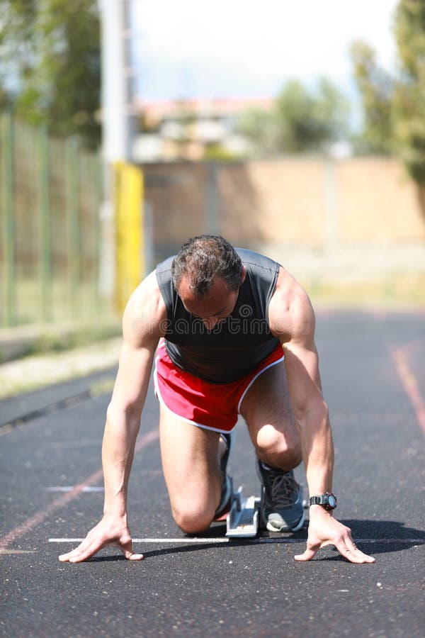 Runner on the Starting Blocks in Position Stock Photo - Image of energy ...