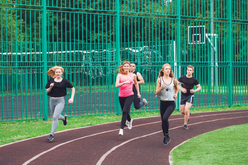 Professional Runners Running on a Race Track Stock Image - Image of ...