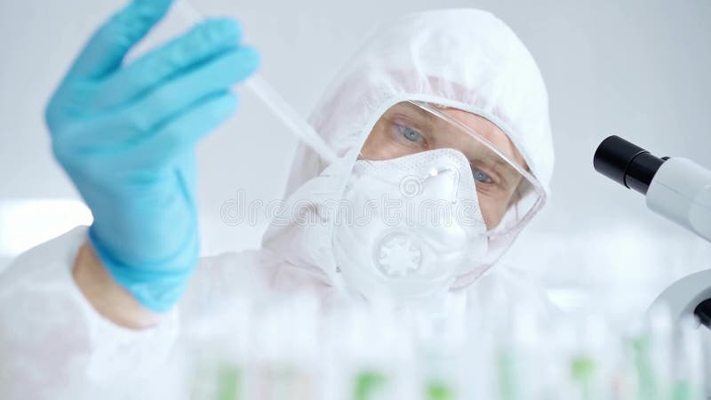 Professional Scientist in Protective Gear is Using Pipette and ...