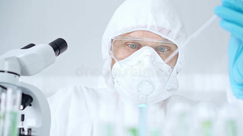 Professional Scientist in Protective Gear is Using Pipette and ...