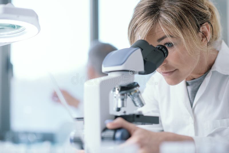 Professional Scientist Using a Microscope Stock Photo - Image of ...